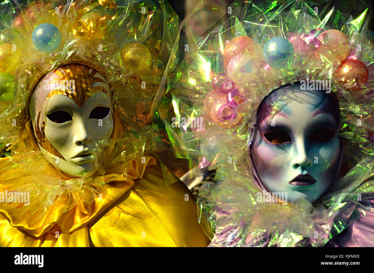 Europe, Italy, Venice Carnival. Two yellow and white masks surrounded ...