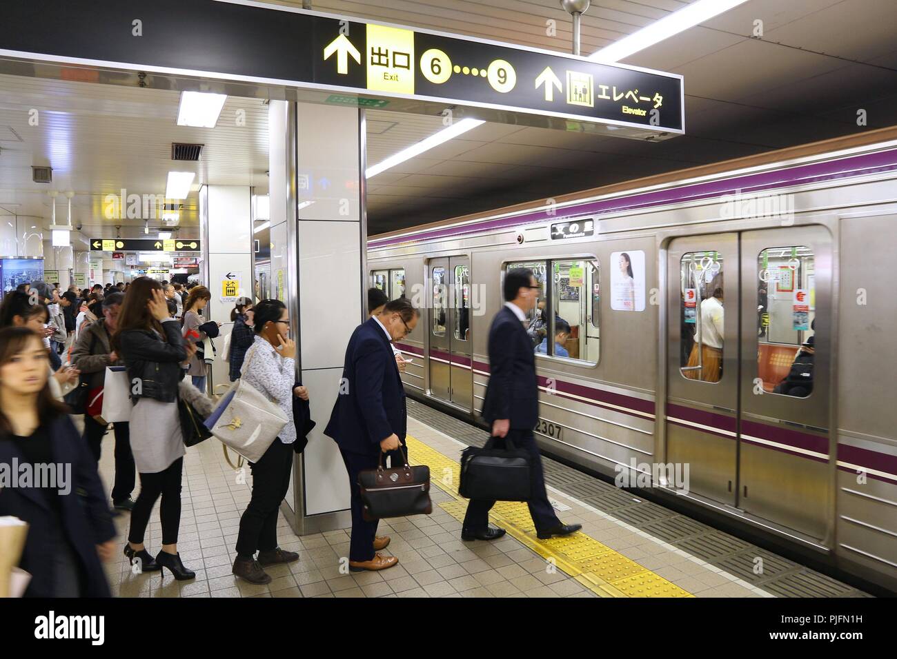 OSAKA, JAPAN - NOVEMBER 22, 2016: People board a subway train in Osaka ...