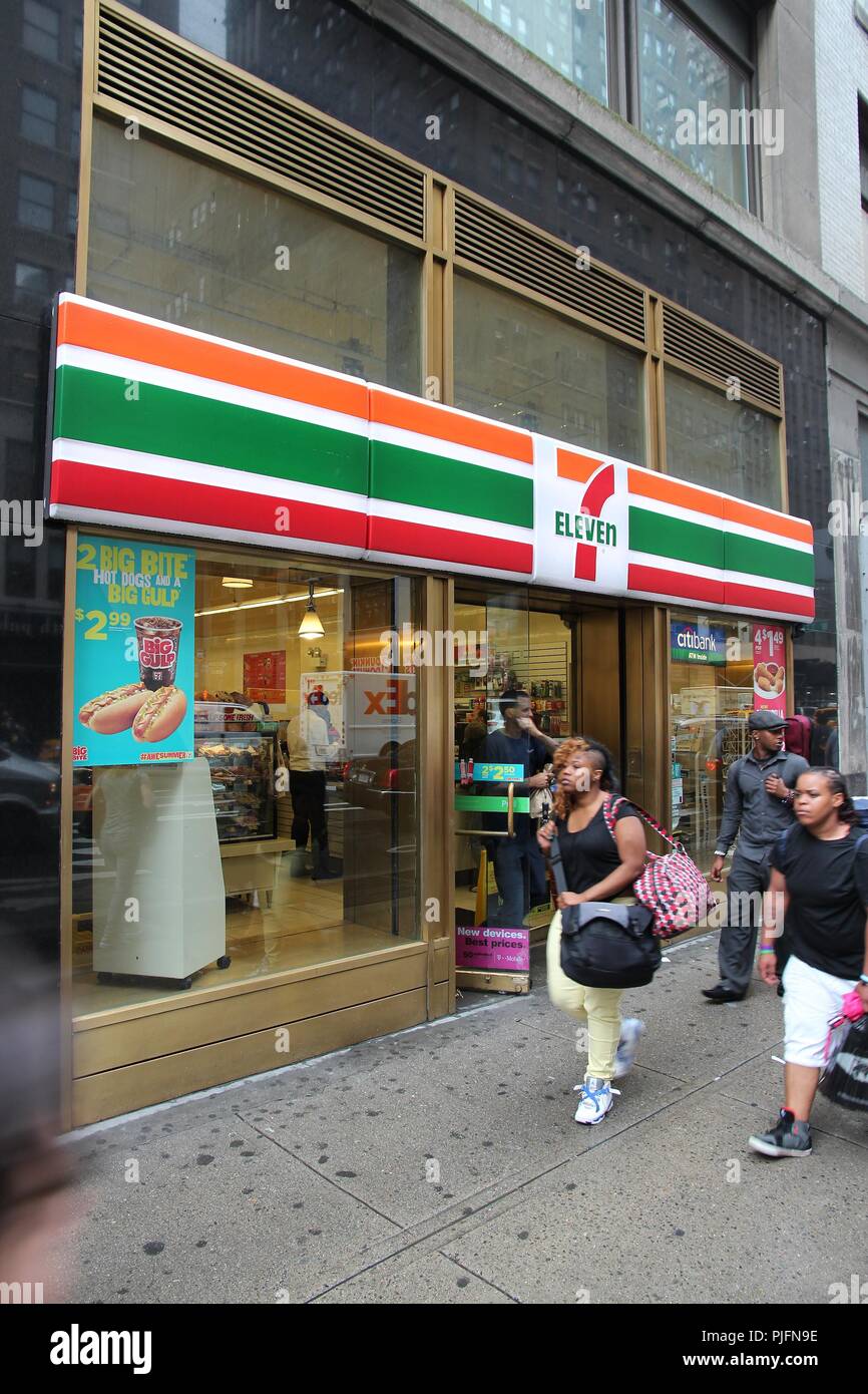 NEW YORK, USA - JULY 1, 2013: People walk past 7-Eleven convenience ...