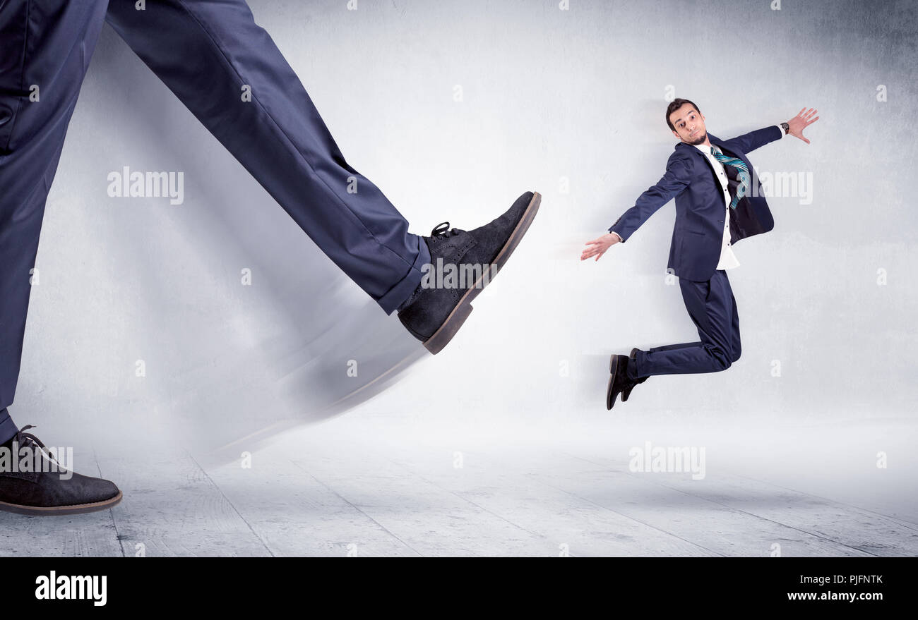 Giant leg kicking small businessman and he is flying away Stock Photo ...