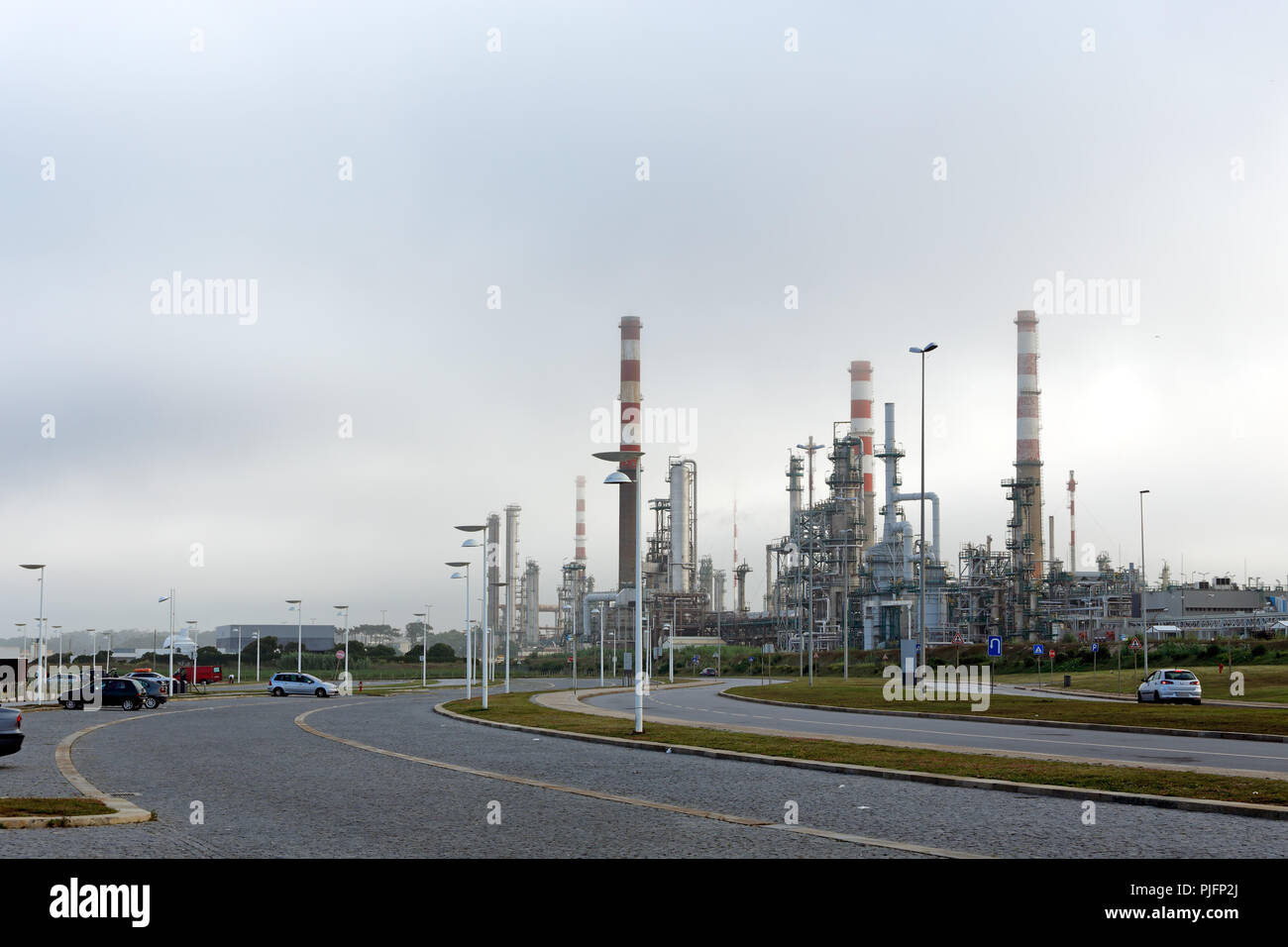 Oil refinery near a road in the morning mist Stock Photo - Alamy