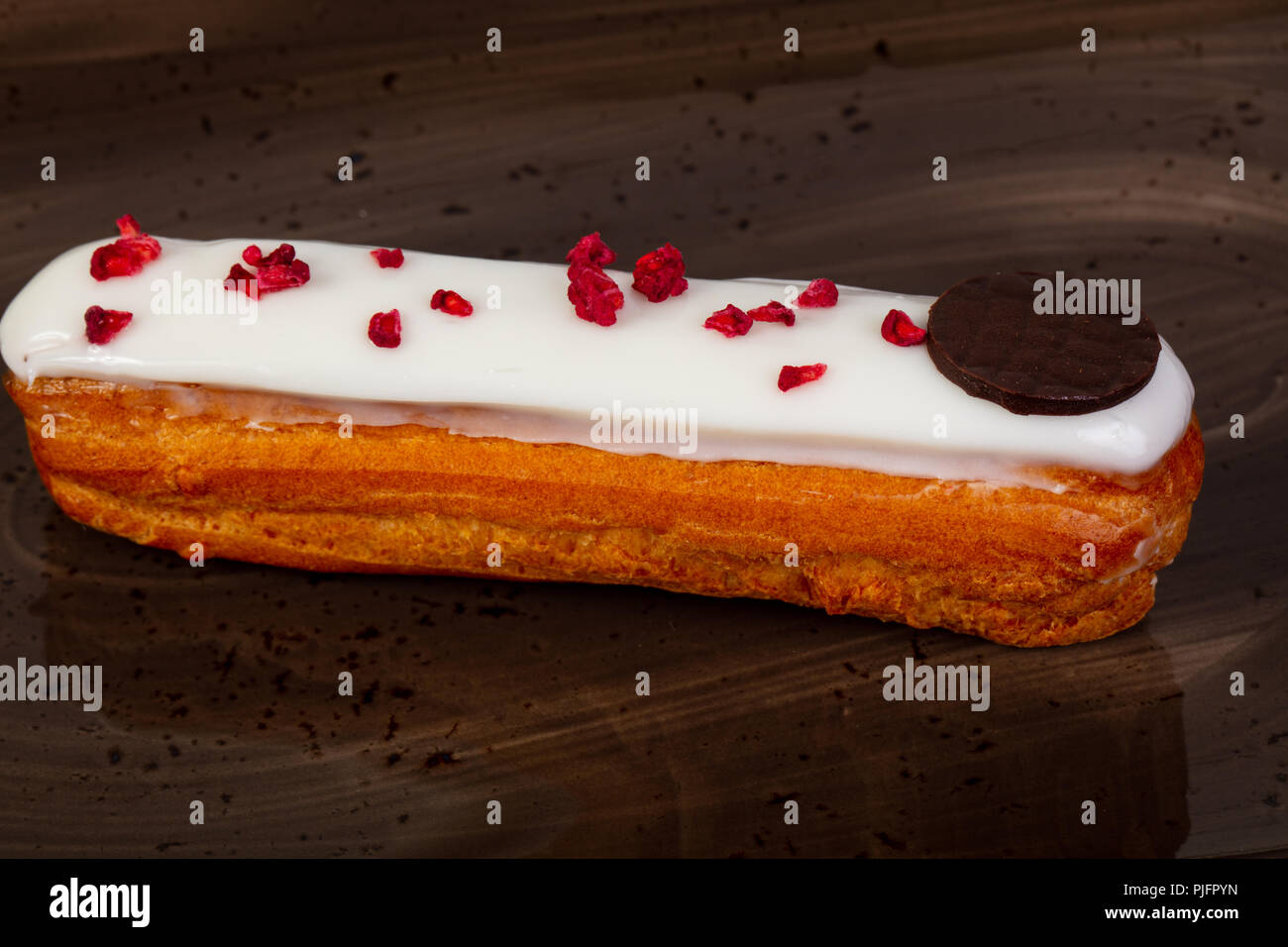 Tasty sweet Eclair with cream Stock Photo - Alamy