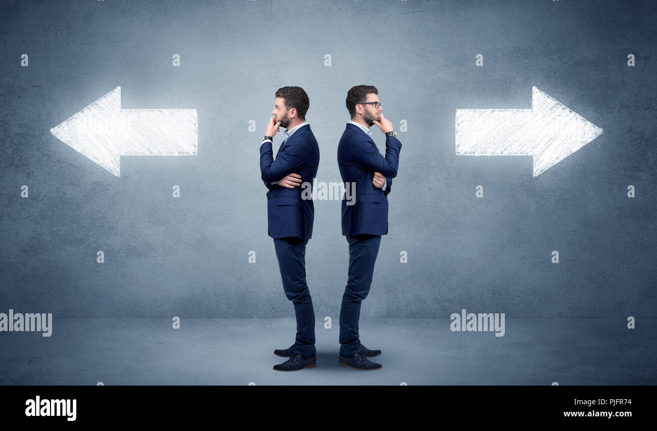 Young conflicted businessman choosing between two directions Stock ...