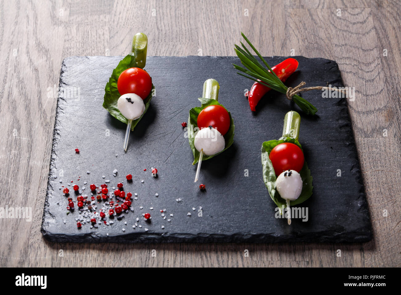 Canape caprese with olive oil Stock Photo - Alamy