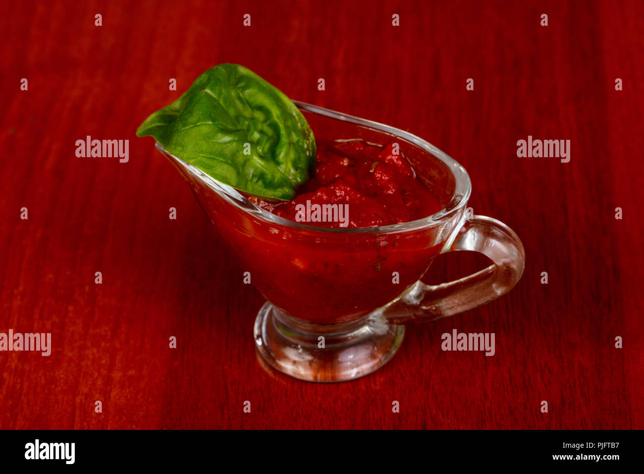 Hot Spicy sauce served basil leaves Stock Photo - Alamy