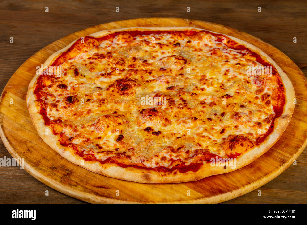 Pizza four cheeses with tomatoes Stock Photo - Alamy