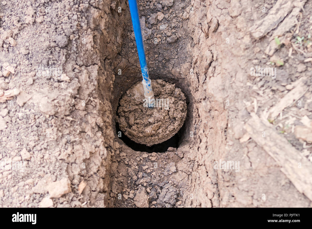 Excavation of soil from the pit by means of a hand drill Stock Photo ...
