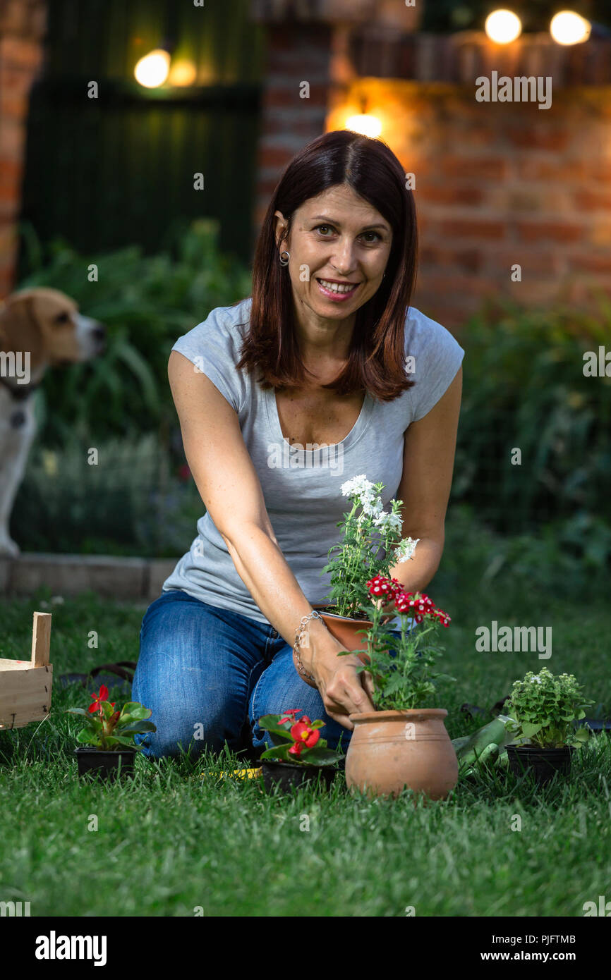 Beautiful mid age woman doing some gardening in her backyard Stock ...