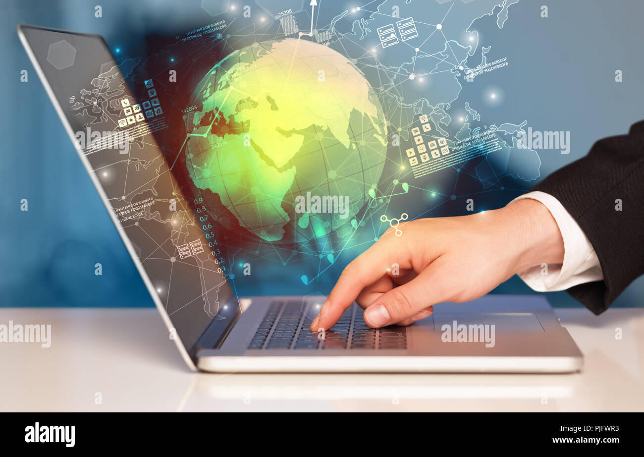 Hand using laptop with global reports and stock market change concept ...