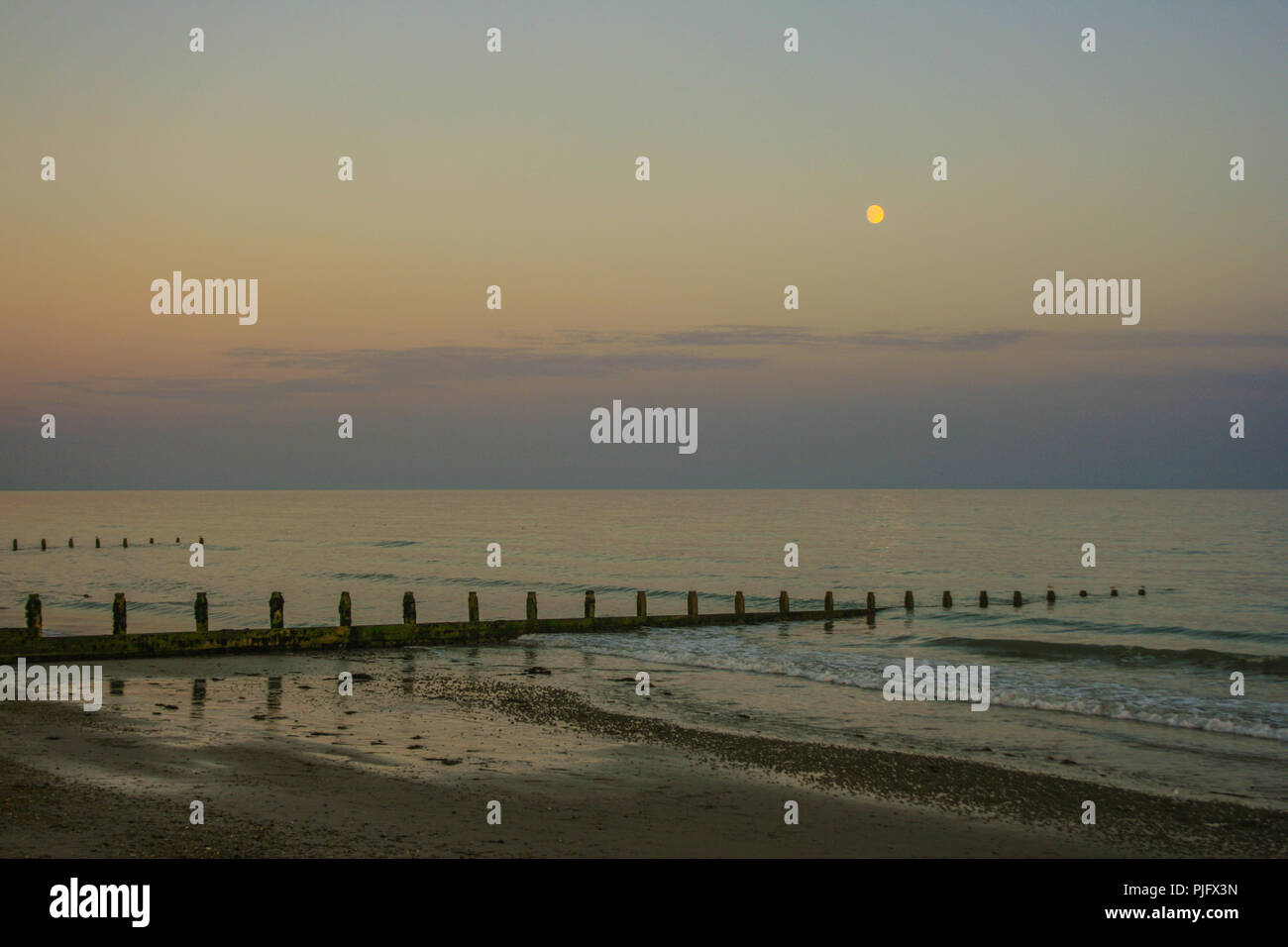 Moon rising above the beach Stock Photo - Alamy