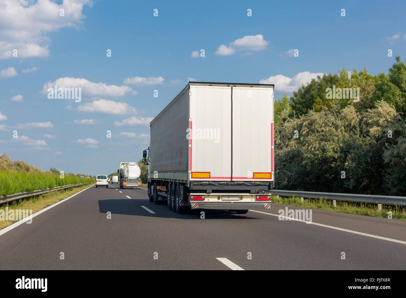 White truck on highway road on sunny day. Industrial transportation ... White truck on highway road on sunny day. Industrial transportation ...