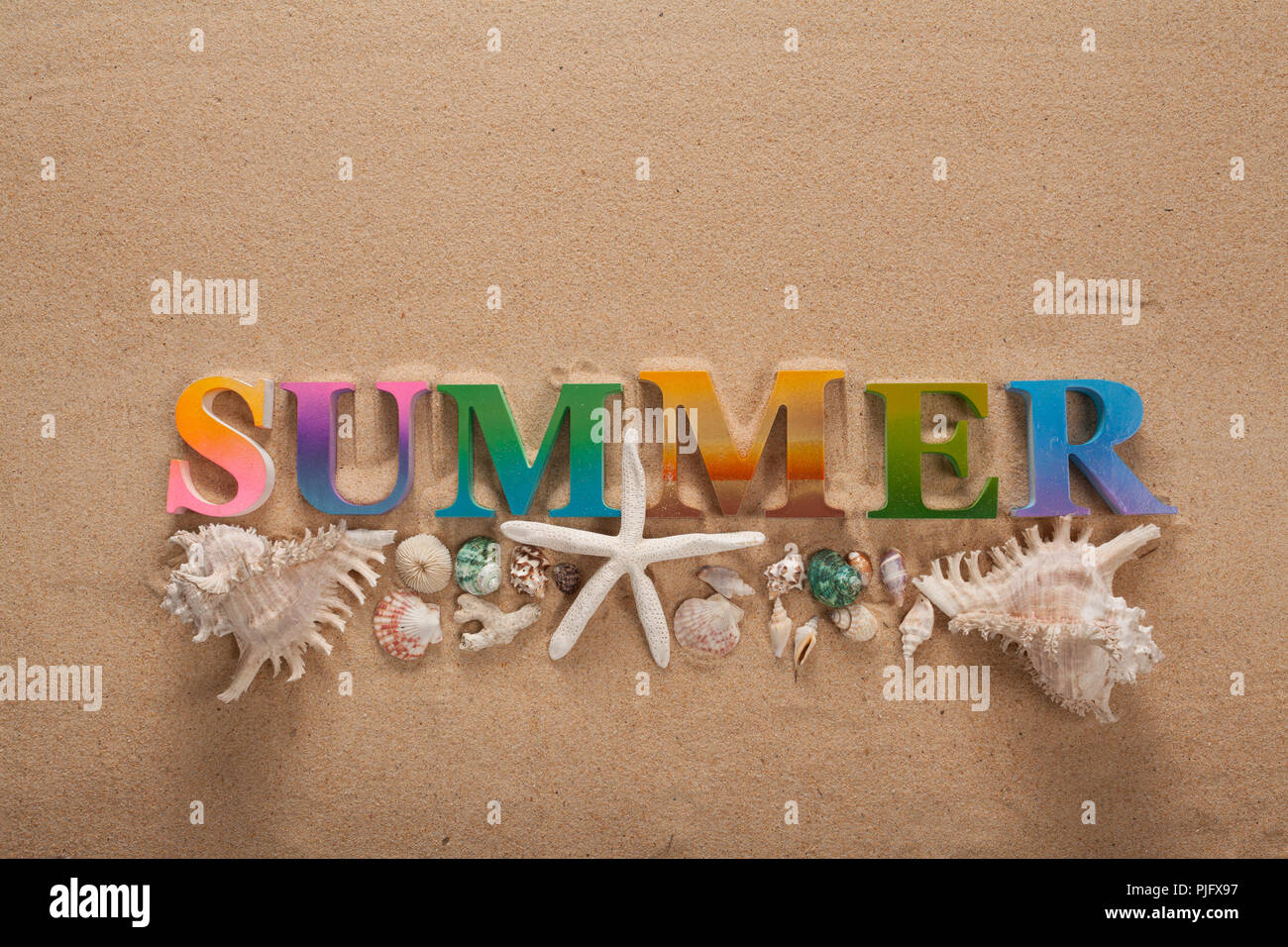 summer written in colorful letters decorate with starfish on the beach ...