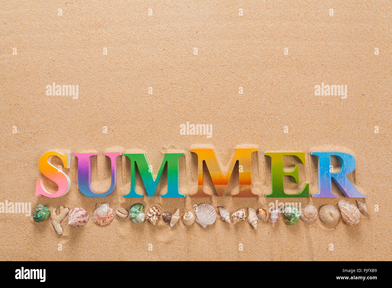 summer written in colorful letters decorate with starfish on the beach ...