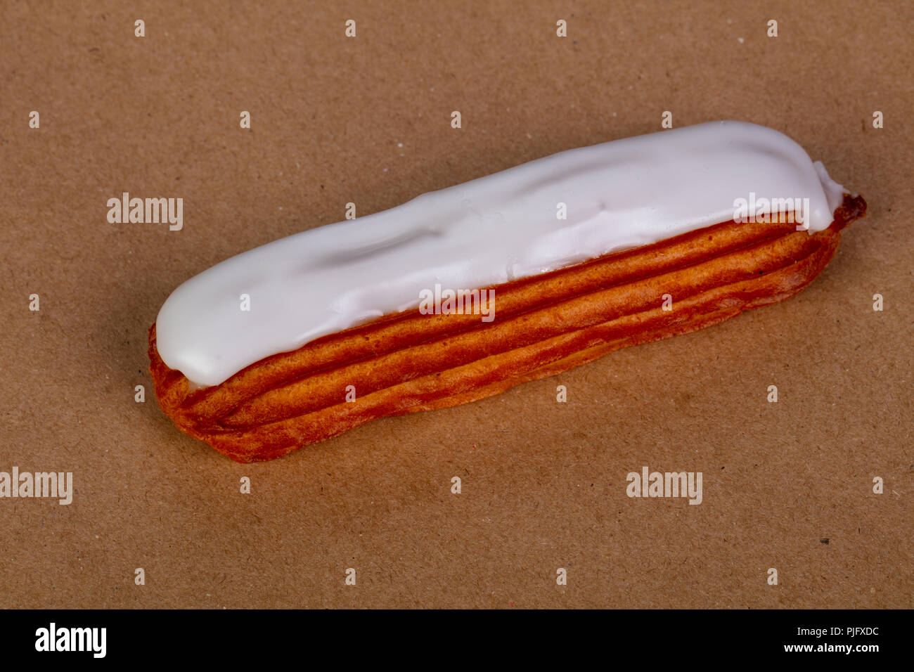 Eclair with cream and icing Stock Photo - Alamy