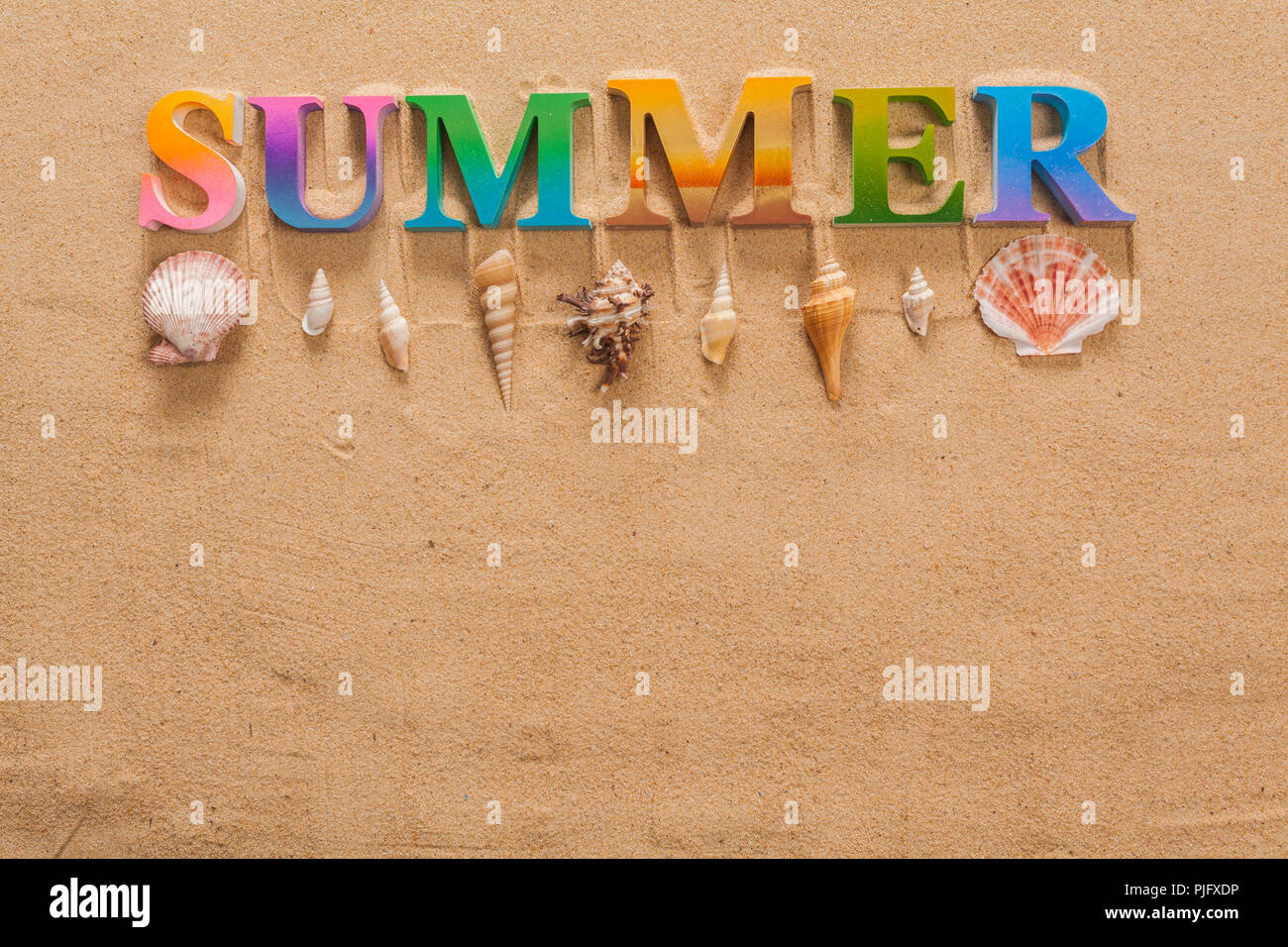 summer written in colorful letters decorate with starfish on the beach ...