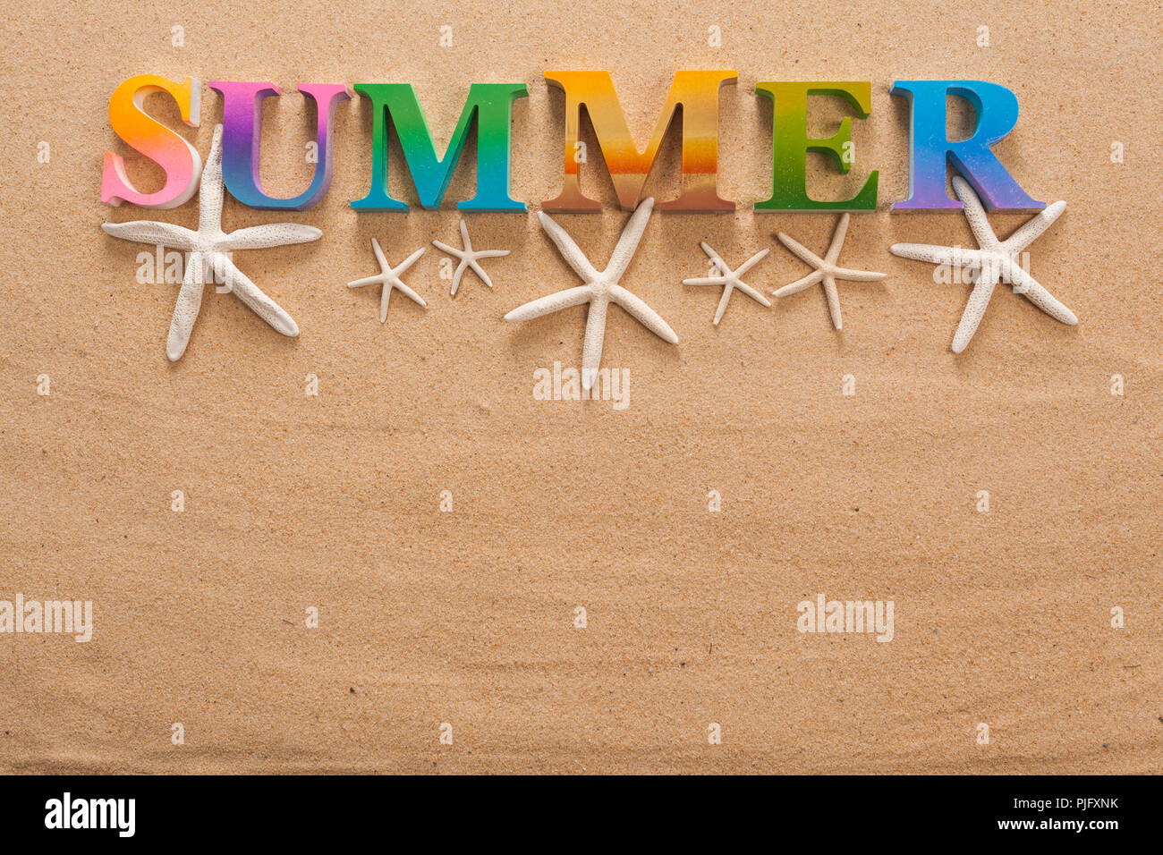 summer written in colorful letters decorate with starfish on the beach ...