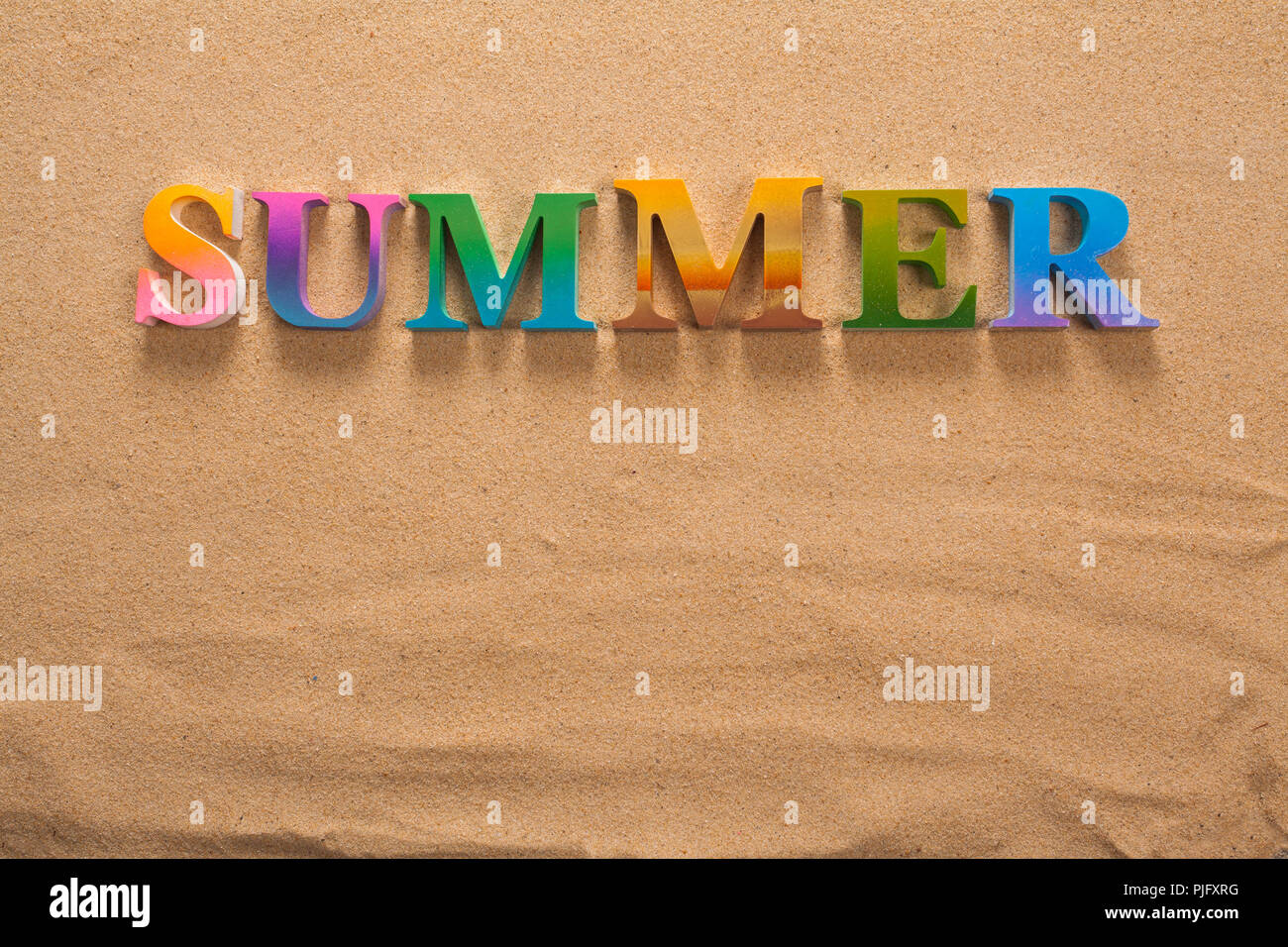 summer written in colorful letters on the beach with copy space Stock ...
