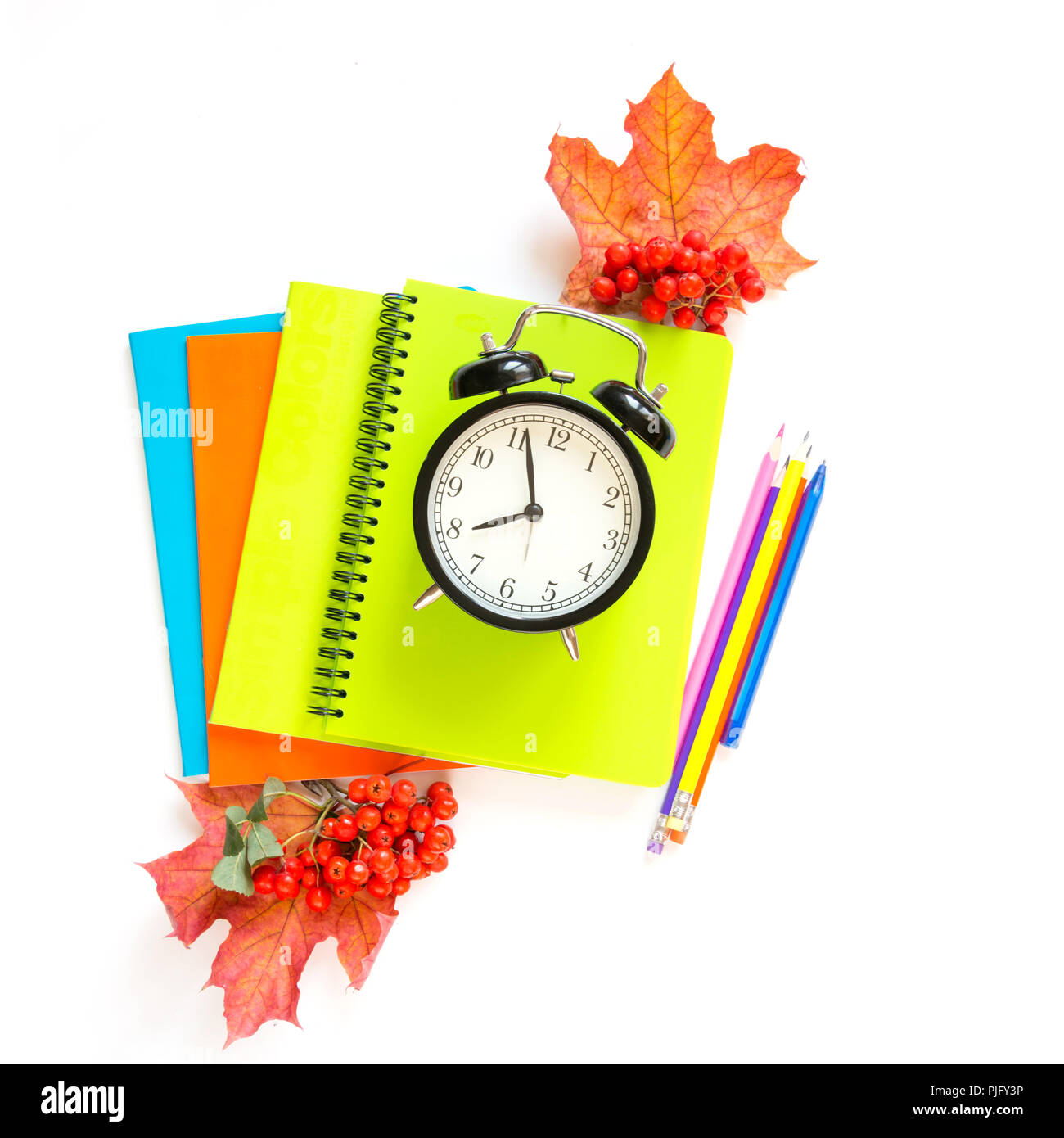 Colorful school supplies, books, alarm clock and pencil on white. Top ...