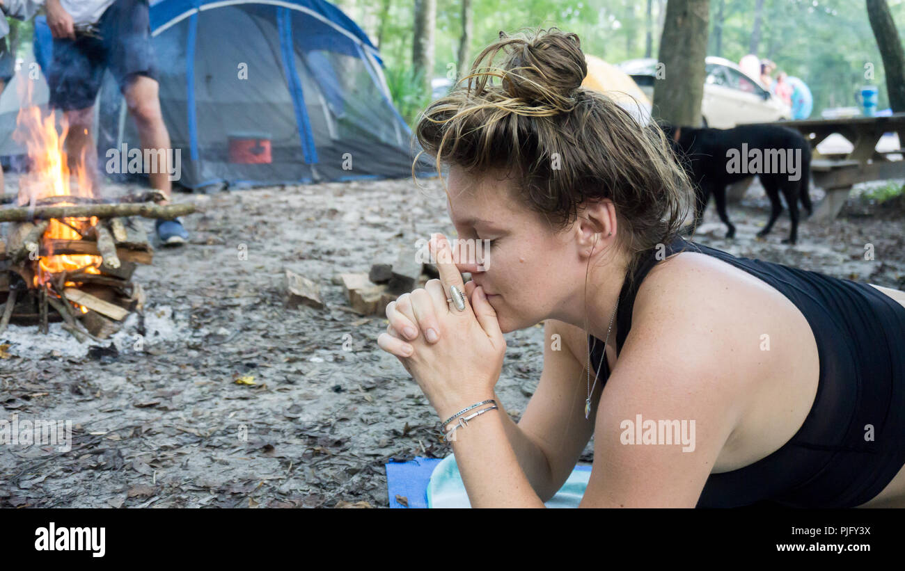 Young woman meditating with Kali mudra hands yoga pose while camping in ...