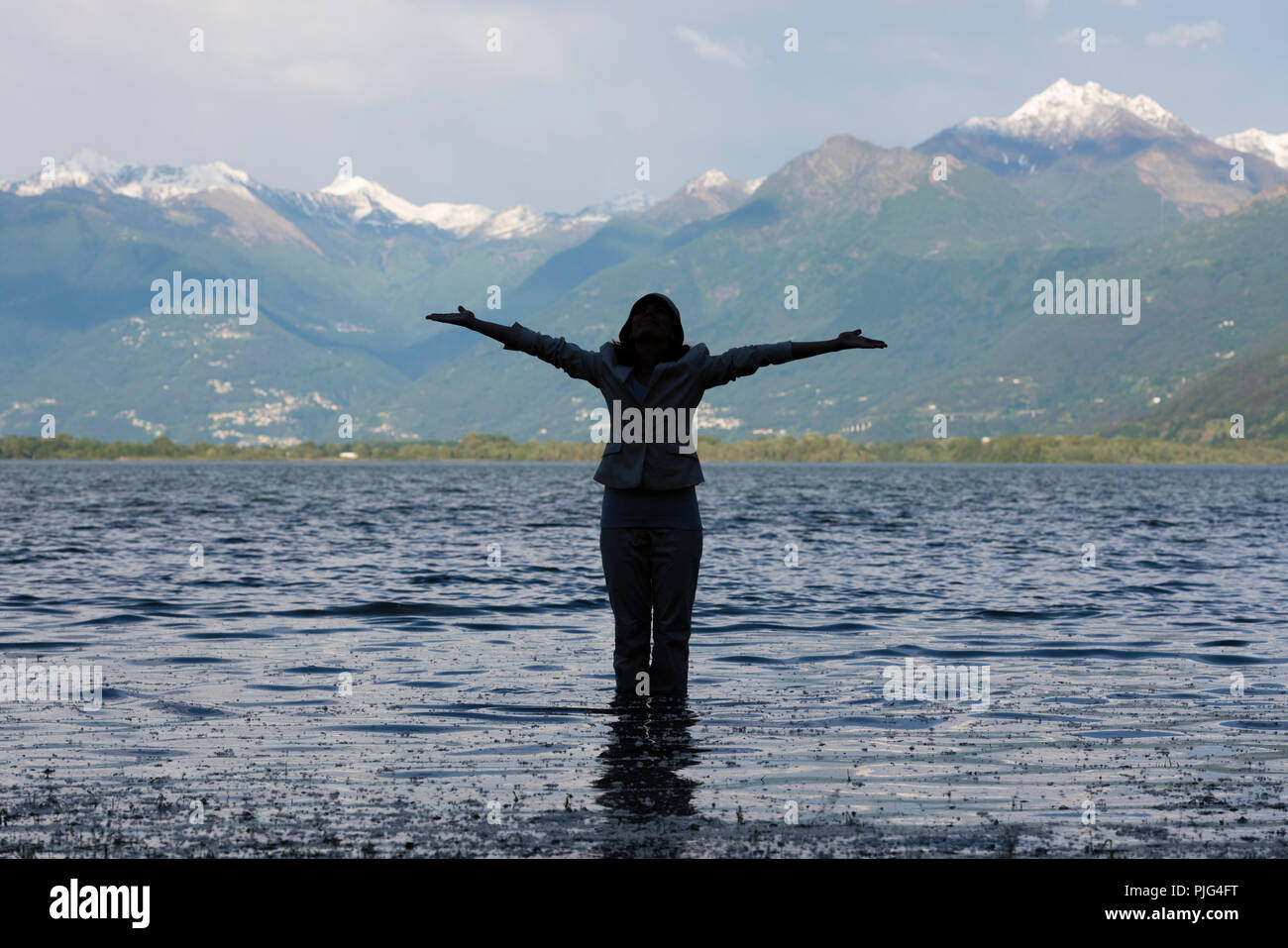 Woman Standing in a Flooding Alpine Lake Maggiore with Snow-capped ...