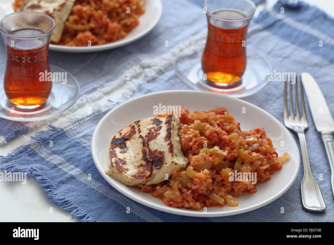 Turkish dinner with grilled halloumi cheese, bulgur pilaf, and Turkish ...