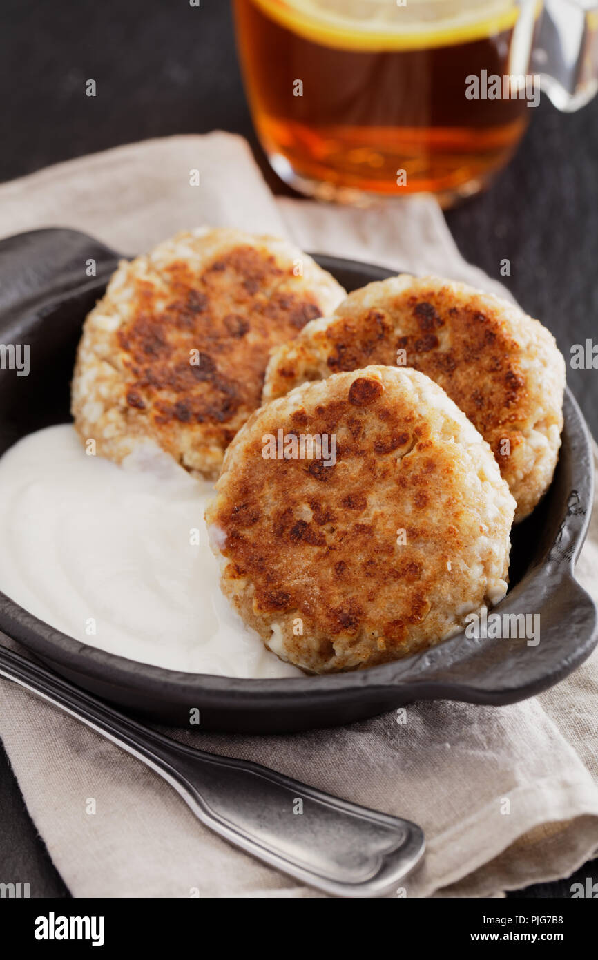 Syrniki, the traditional Russian cheese pancakes on a rustic table ...