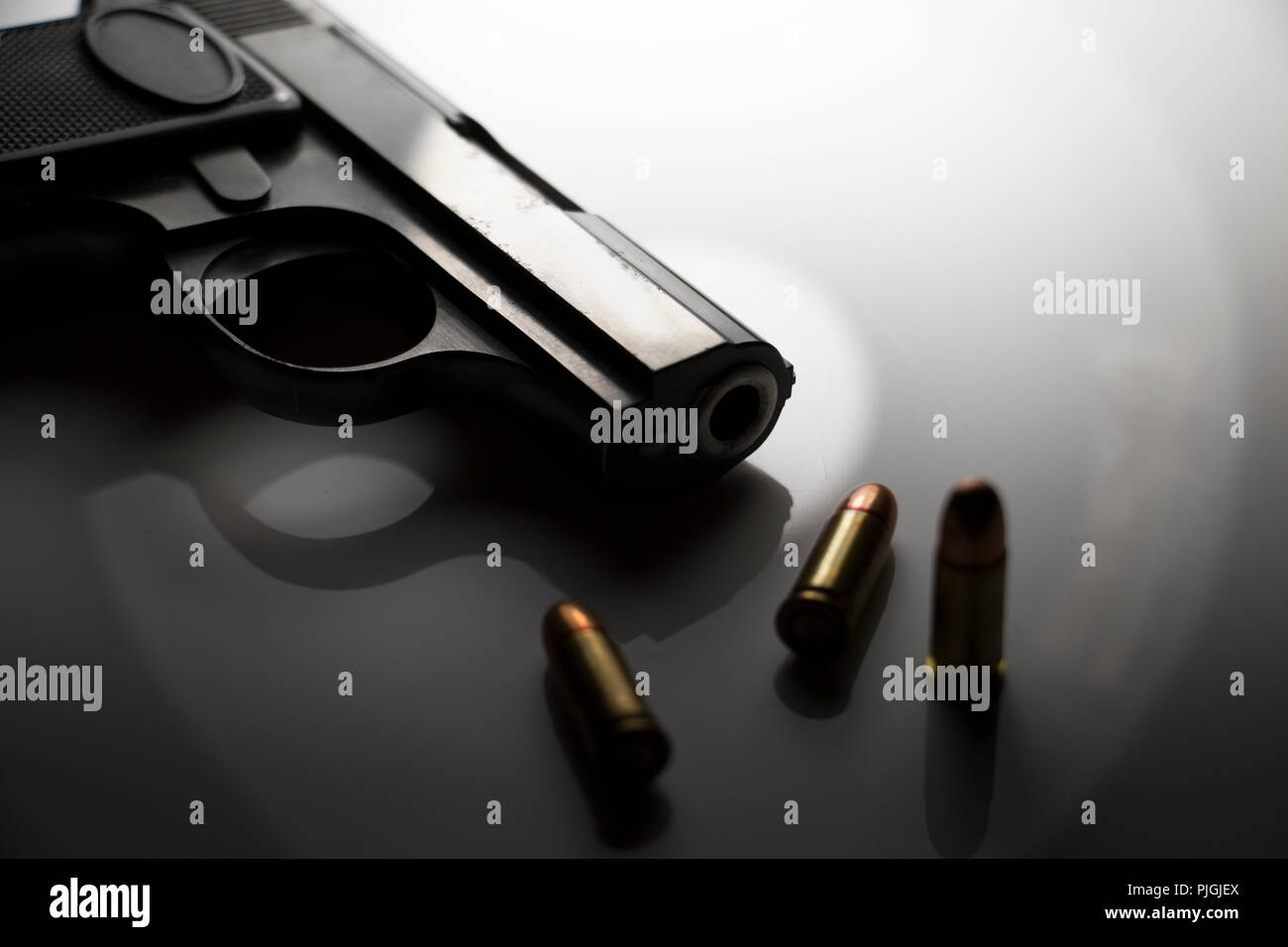 Gun and Bullets on a table. Close up of a hand gun. Slugs of a military ...
