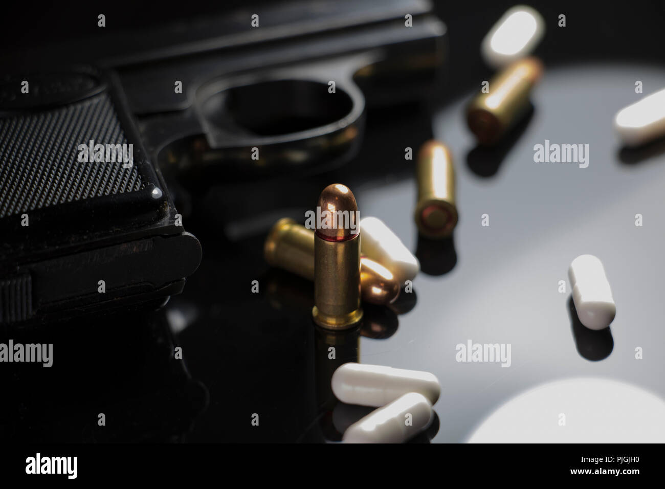 Prescription drugs, psychology and mental illness. Hand Gun with ...