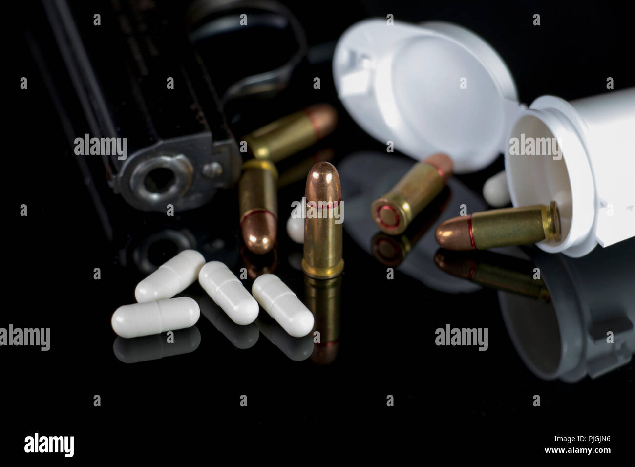 Pain killers bullets and hand gun on a black table Weapons ammo and ...