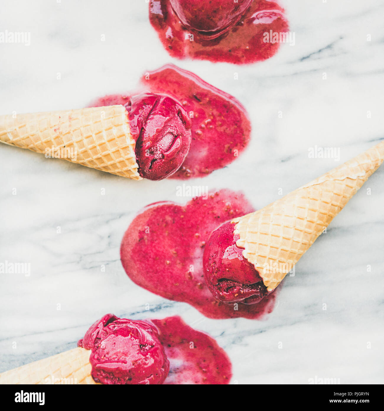 Fresh summer dessert. Flat-lay of red melting natural raspberry sorbet ...