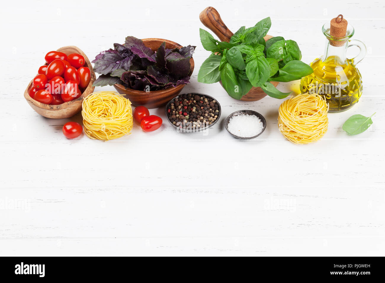 Italian cuisine. Basil, pasta and tomato cooking. With space for your ...