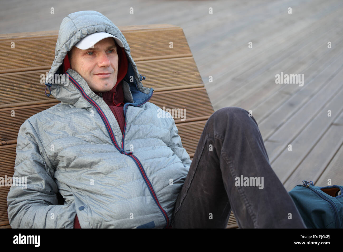 Mature man resting on a lounge chair in a city park Stock Photo - Alamy
