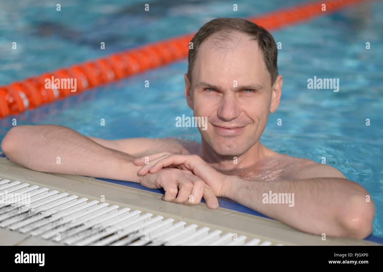 Happy man in a swimming pool Stock Photo - Alamy