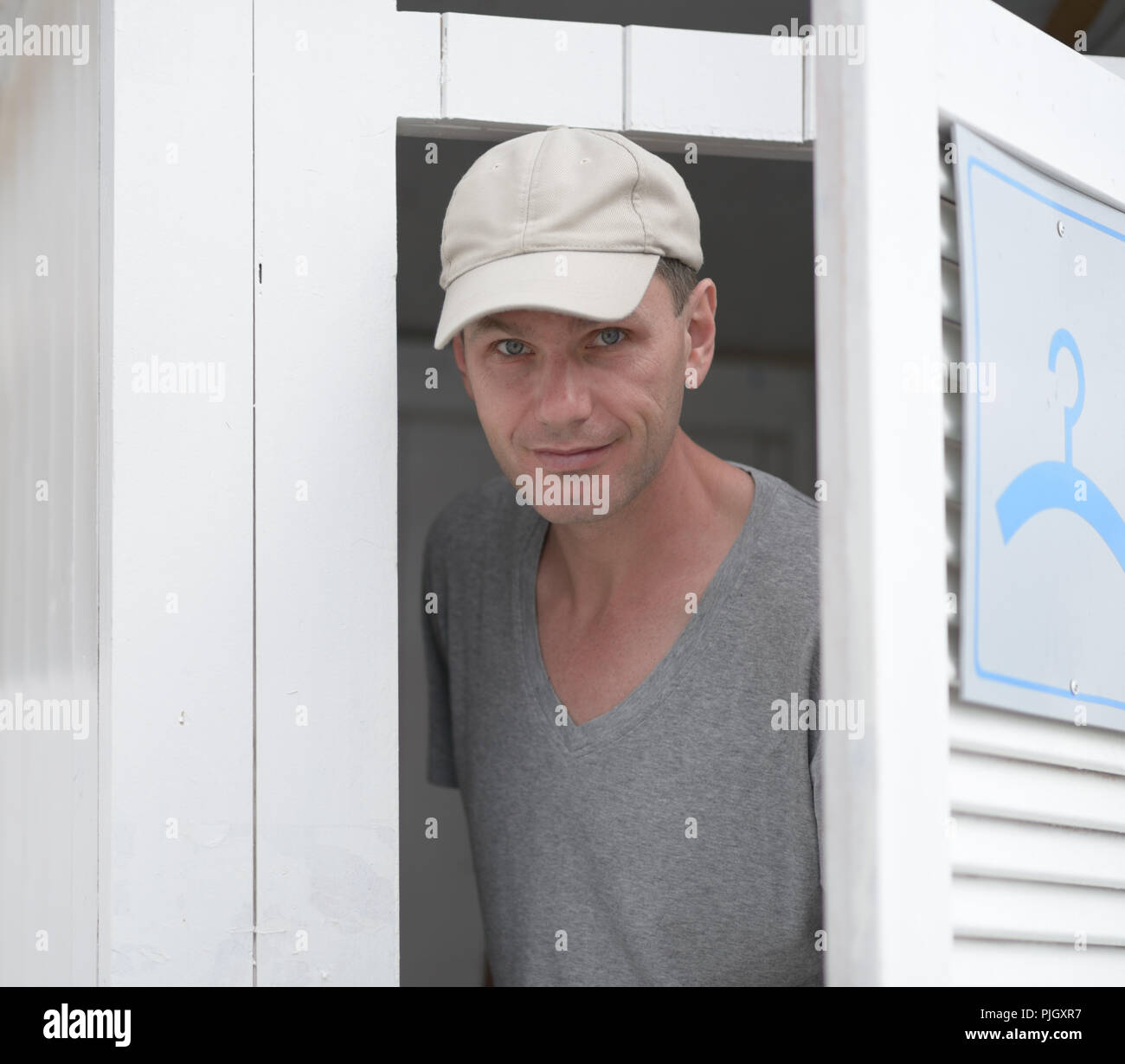 Man exiting from changing stall on a beach Stock Photo - Alamy