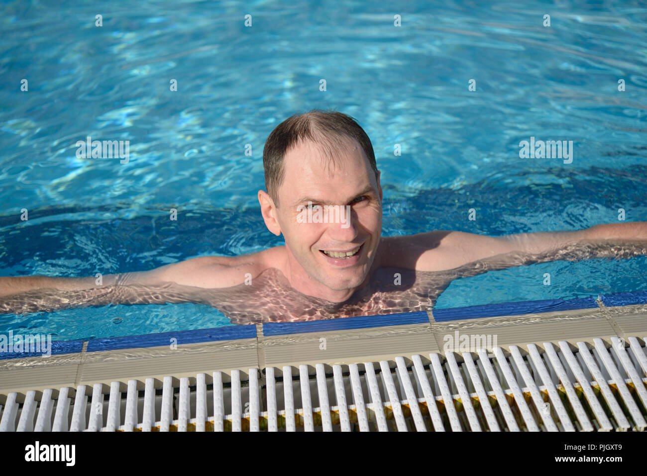 Happy man in a swimming pool Stock Photo - Alamy