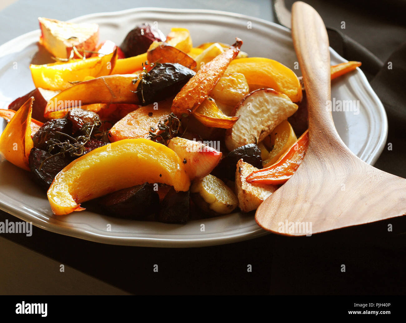 Grilled fall seasonal vegetables on plate over a dark background Stock ...
