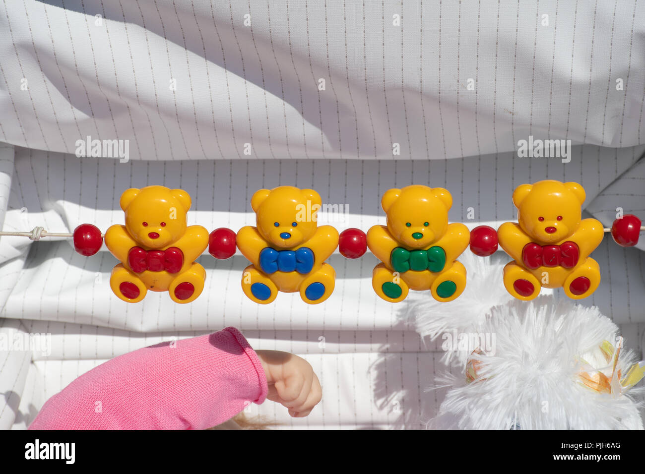Row of plasic teddys in baby's pushchair Stock Photo - Alamy
