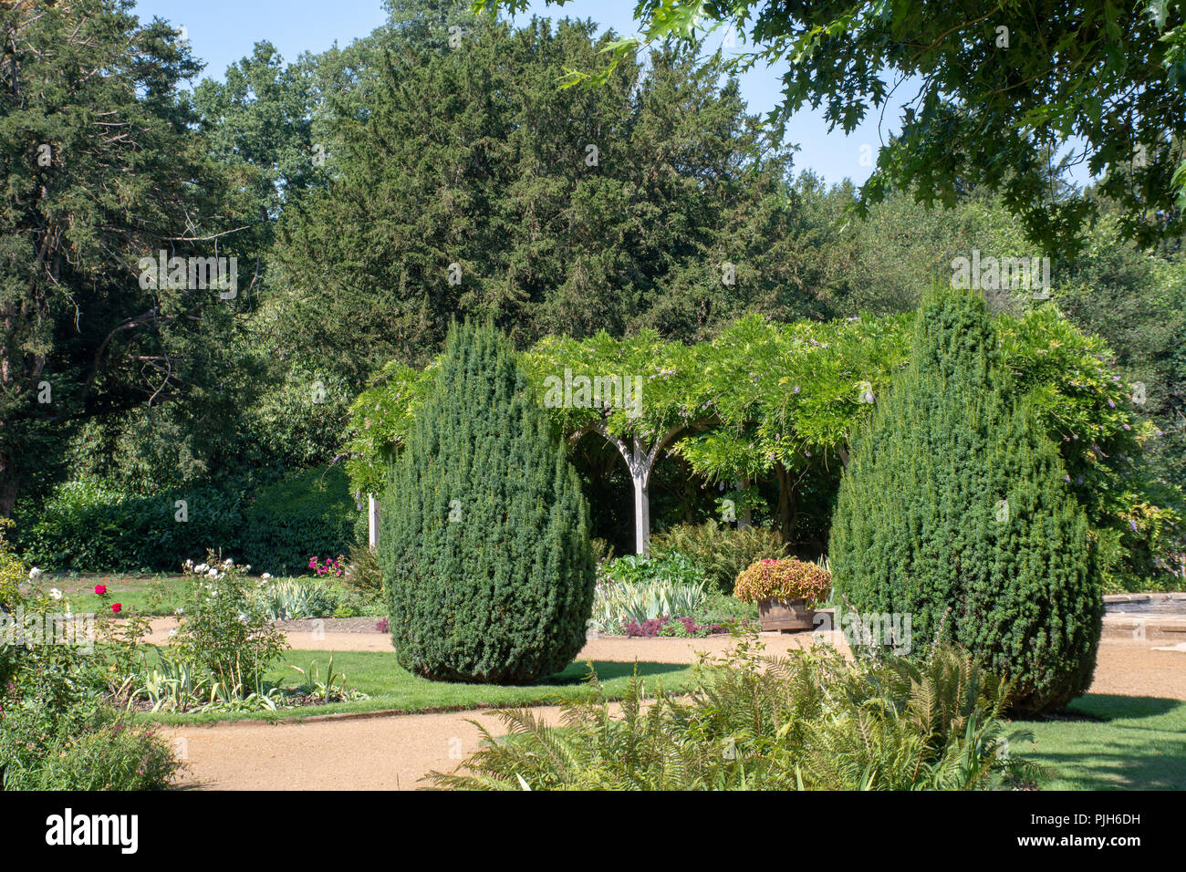 Traditional English garden with arbour and trees and path Stock Photo ...