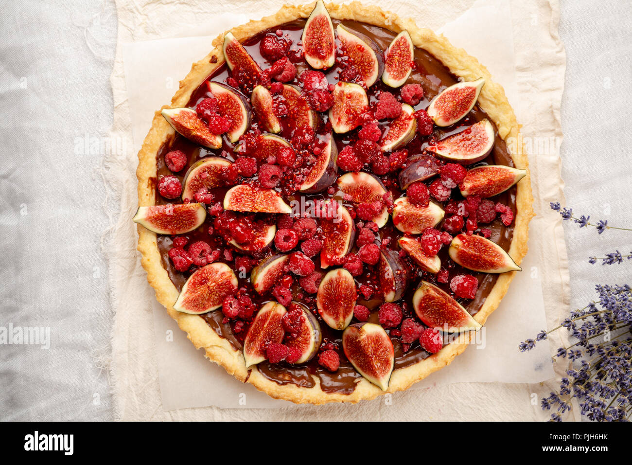 Tasty tart with figs and raspberry, top view Stock Photo - Alamy