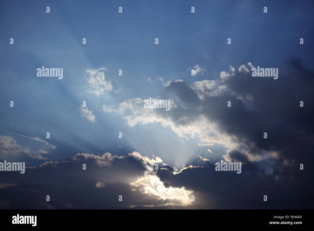 Sun beams coming through clouds Stock Photo - Alamy