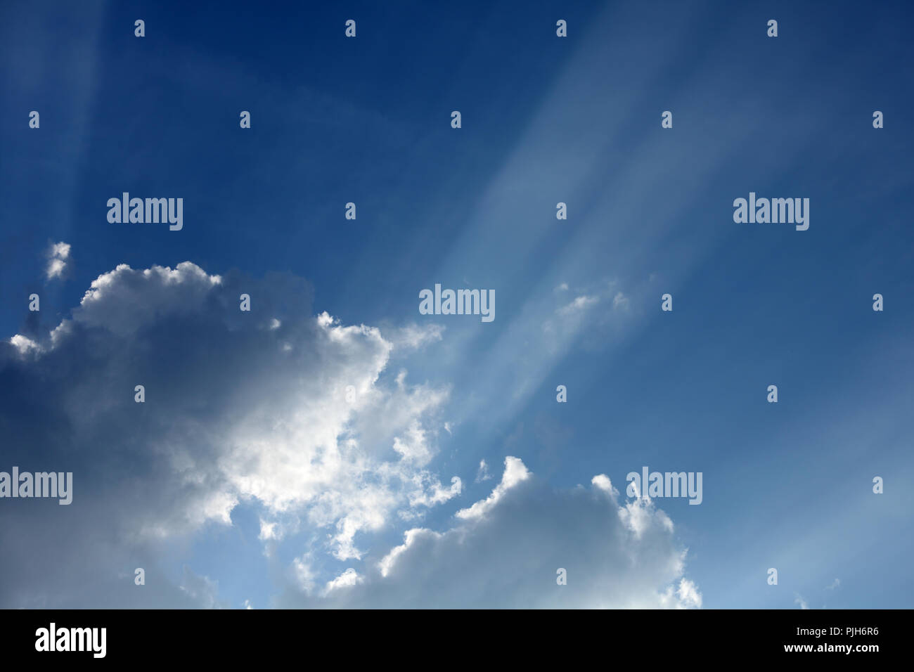 Sun beams coming through clouds Stock Photo - Alamy