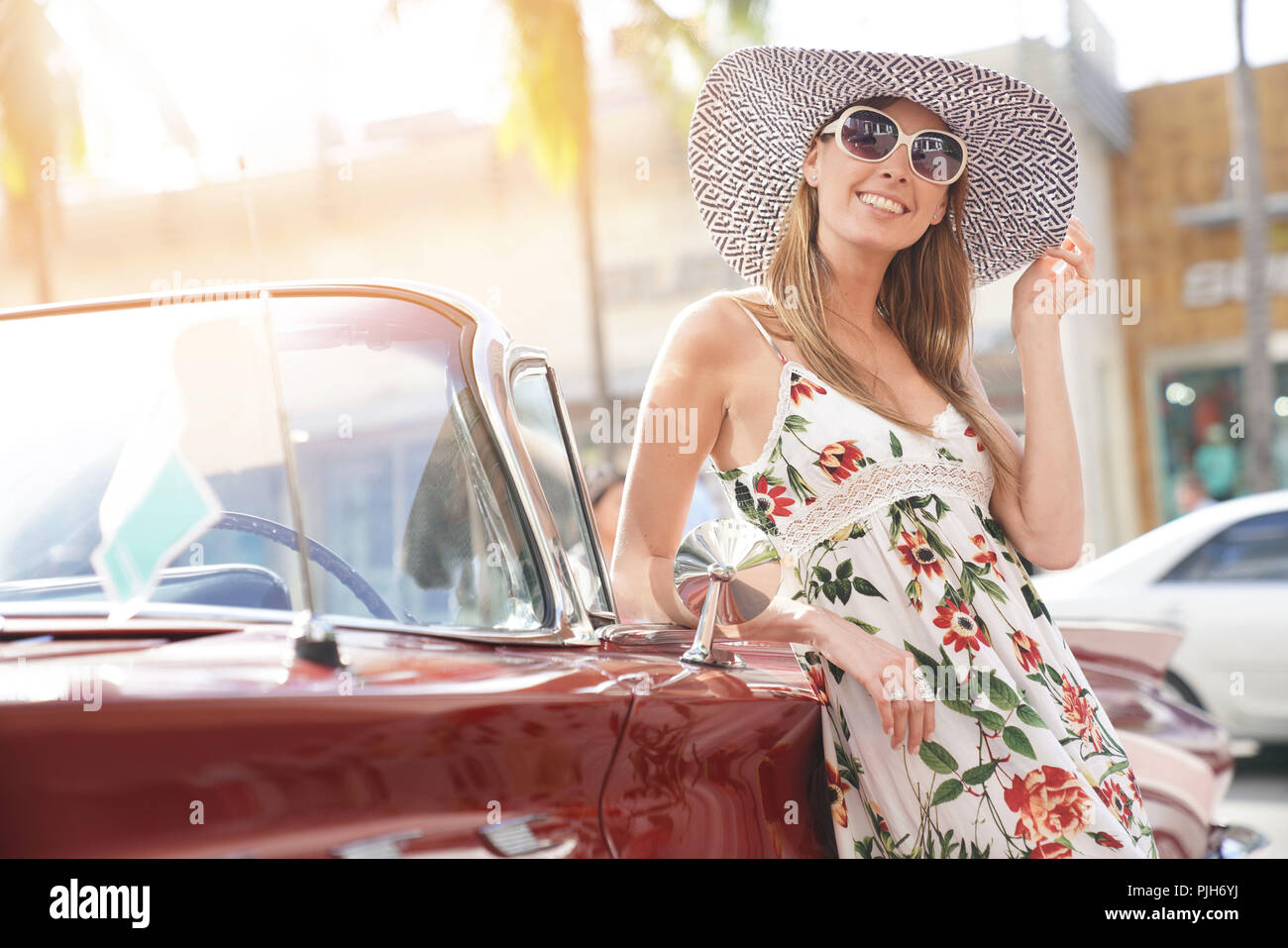 Model posing by old-fashioned car Stock Photo - Alamy