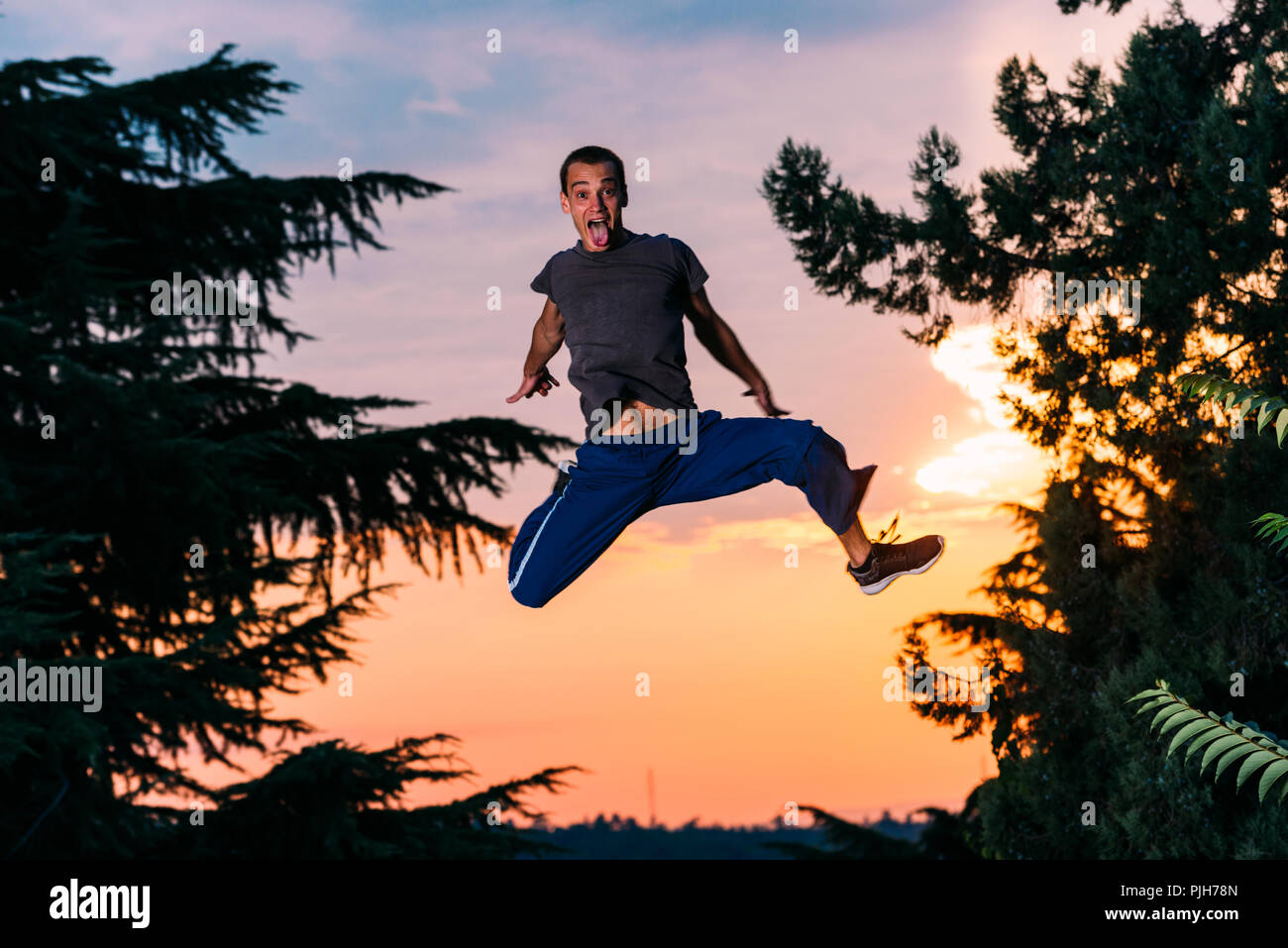 Free runner man exercise parkour outdoor while jumping Stock Photo - Alamy