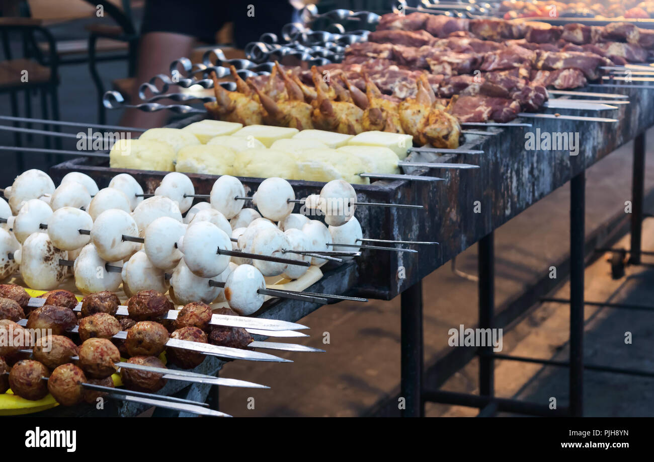 Street food and outdoor cooking concept. Vegetables, meat, cheese ...