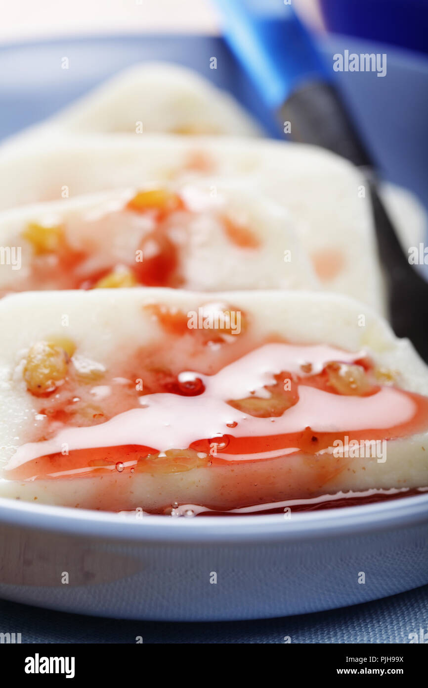 Semolina pudding with raisins and strawberry jam Stock Photo - Alamy