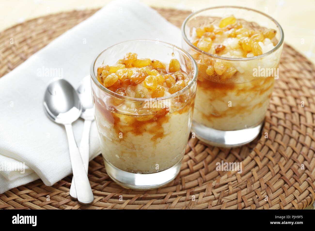 Rice pudding with raisins and cinnamon syrup Stock Photo - Alamy