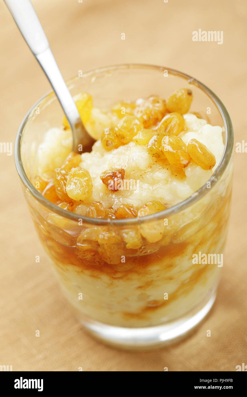 Rice pudding with raisins and cinnamon syrup Stock Photo - Alamy