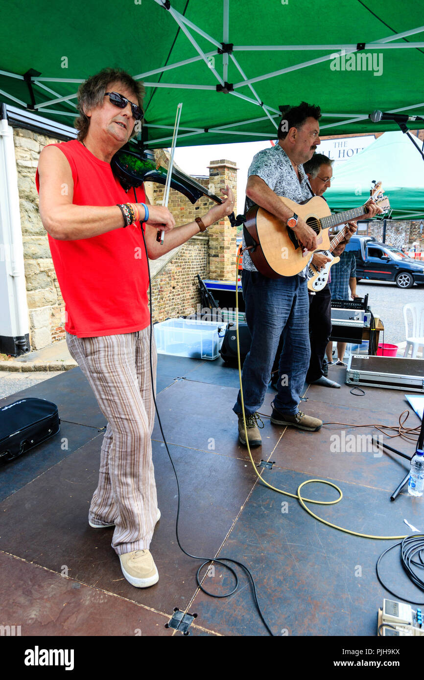 The Hot Rats performing on a small open stage during the Sandwich Folk ...