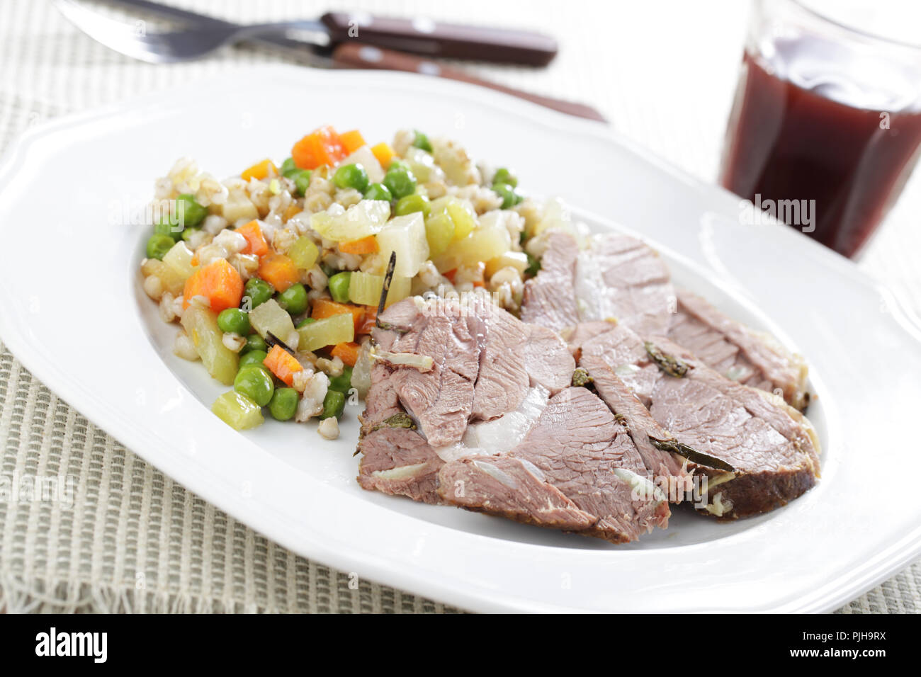 Lamb meat and ragout with pearl barley and vegetables Stock Photo - Alamy
