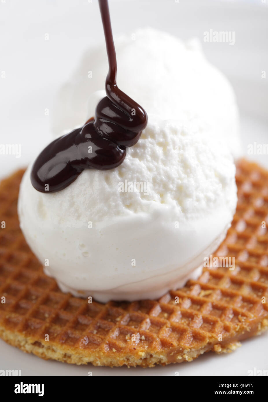 Ice cream spheres on the waffle under the chocolate sauce Stock Photo ...